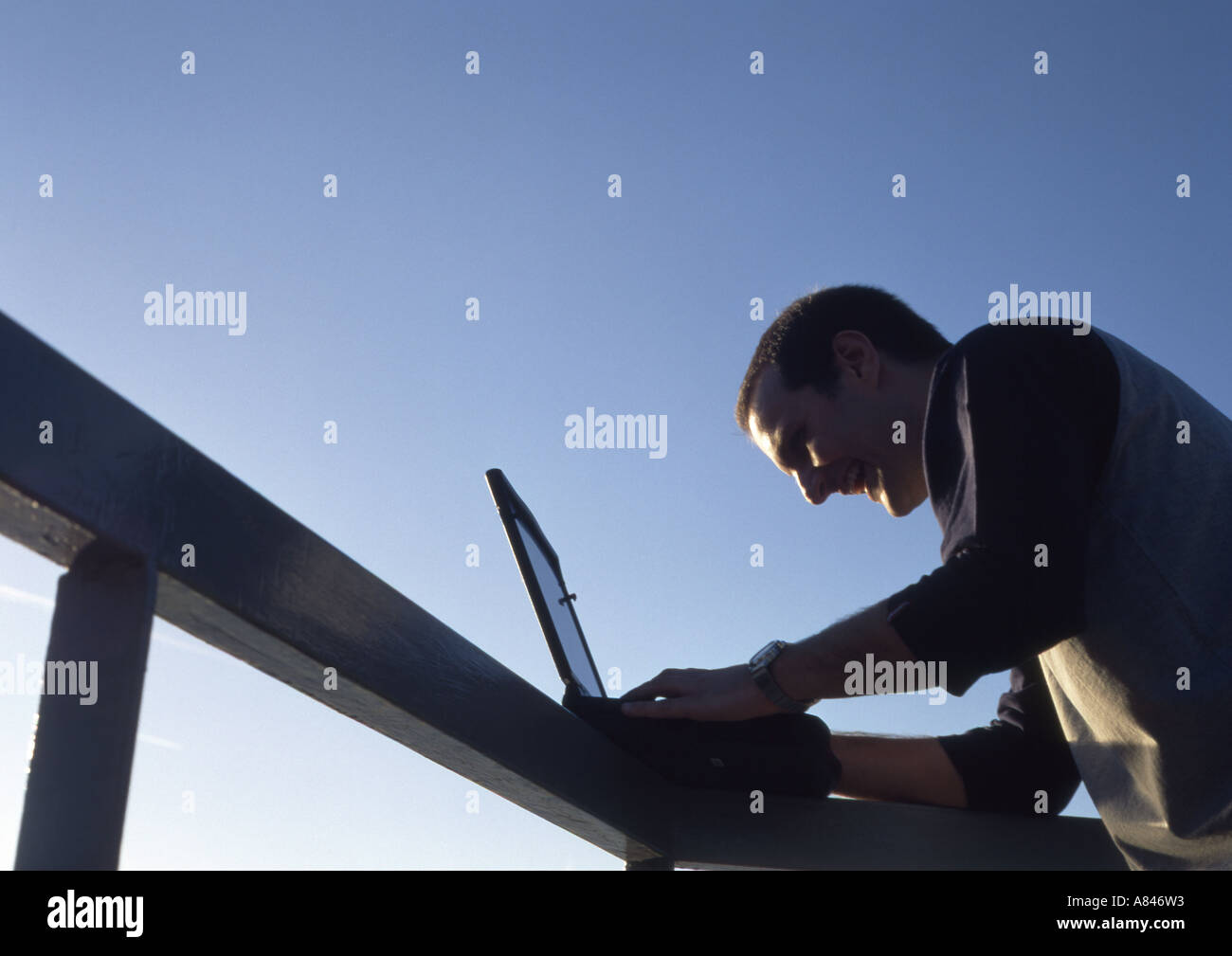 man working on laptop outdoors Stock Photo - Alamy