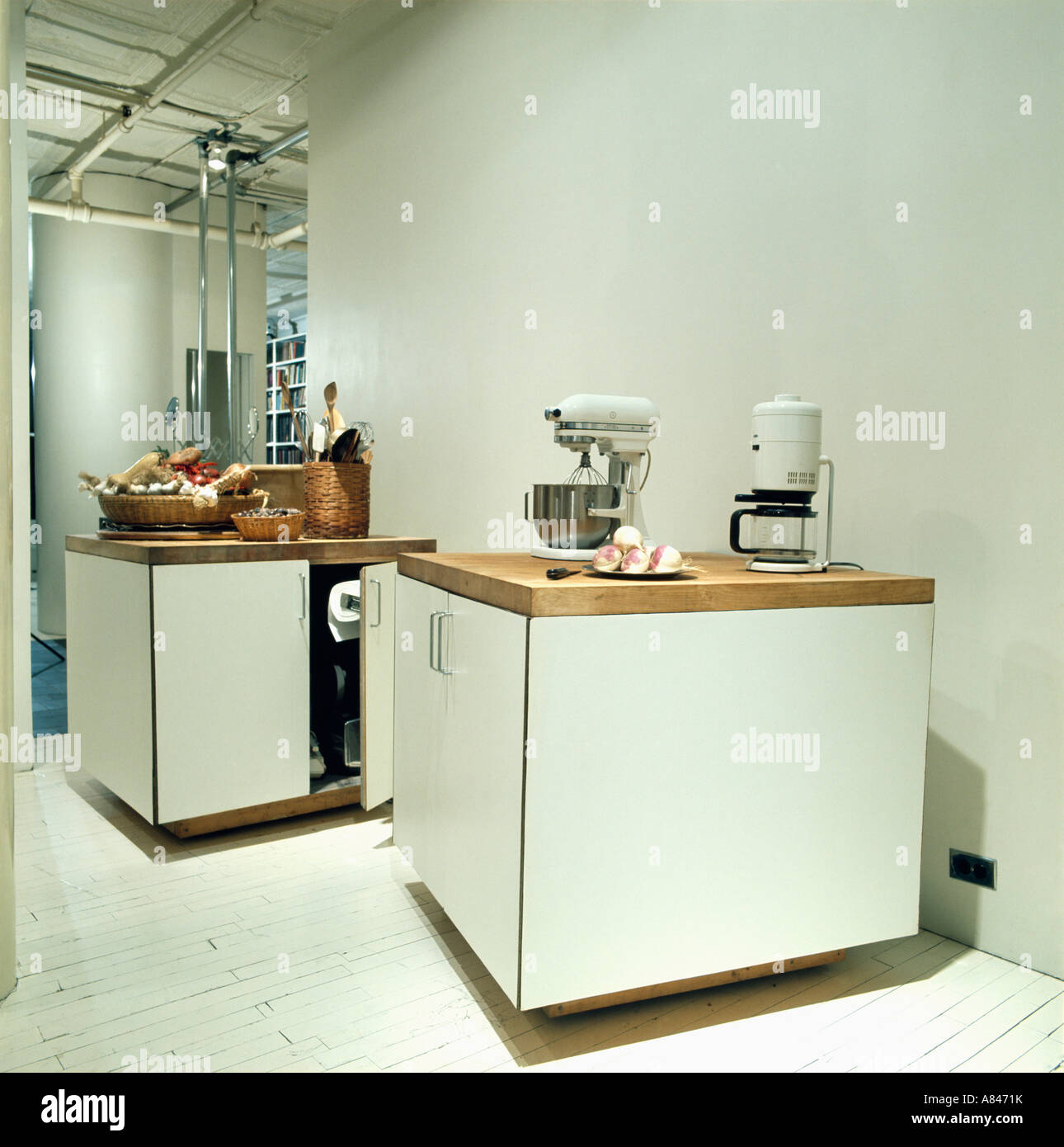 Electric mixer and coffee machine on moveable white island unit in ...