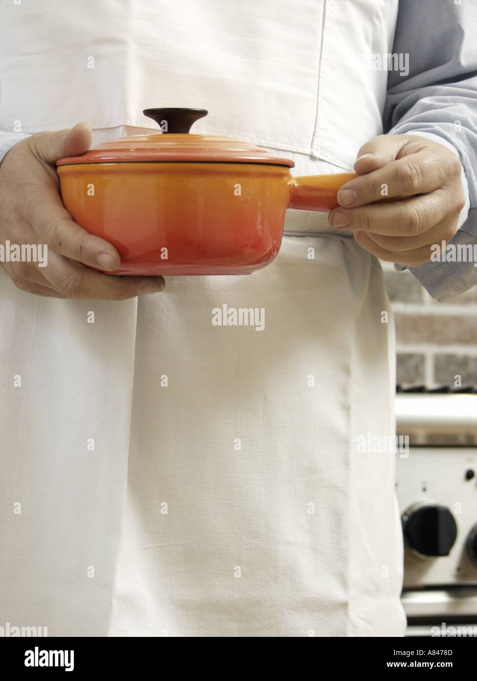 Holding an Orange Pot with Lid Stock Photo - Alamy