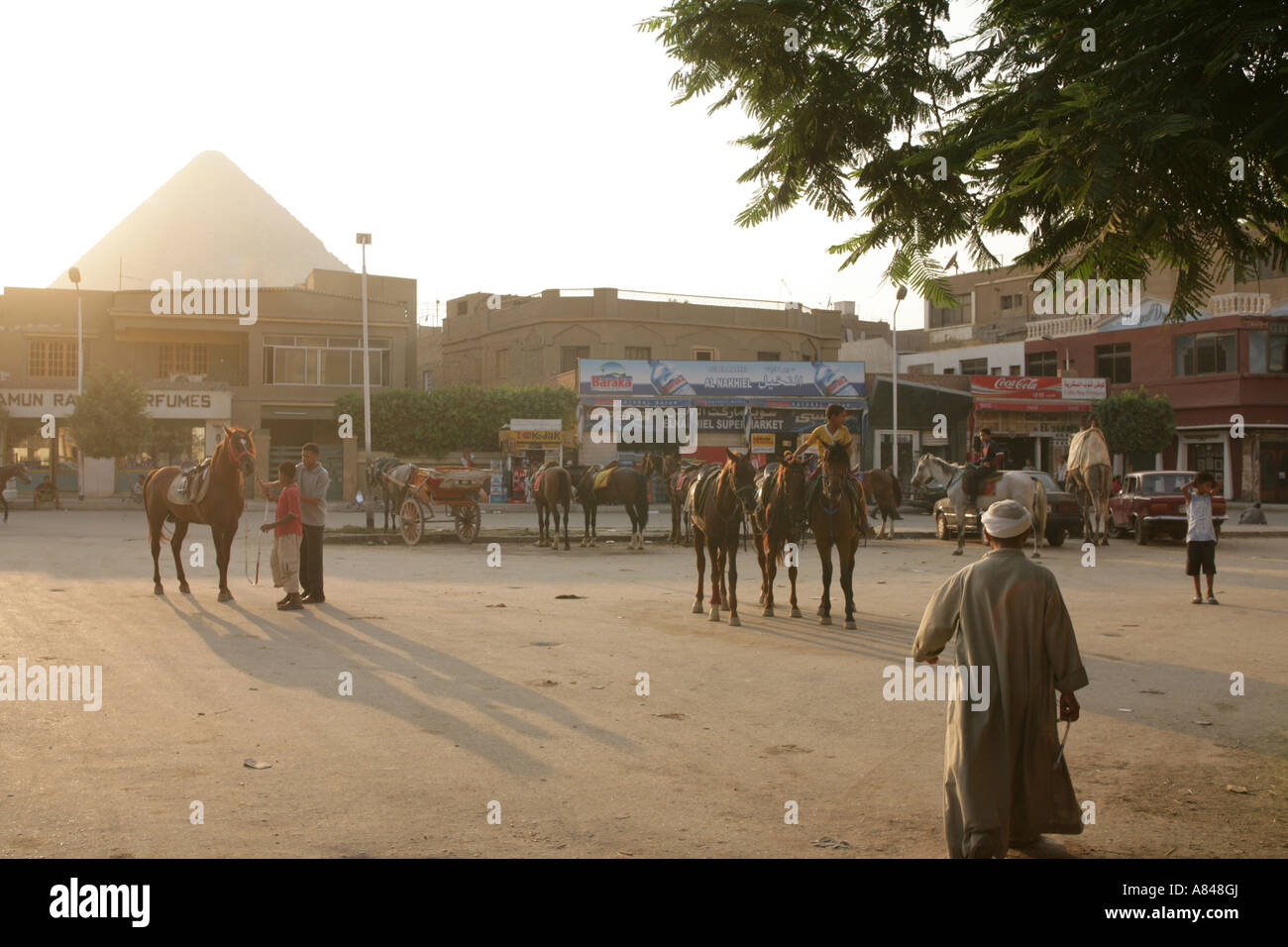 Street scene in Cairo with the pyramid in the background, Cairo, Egypt ...