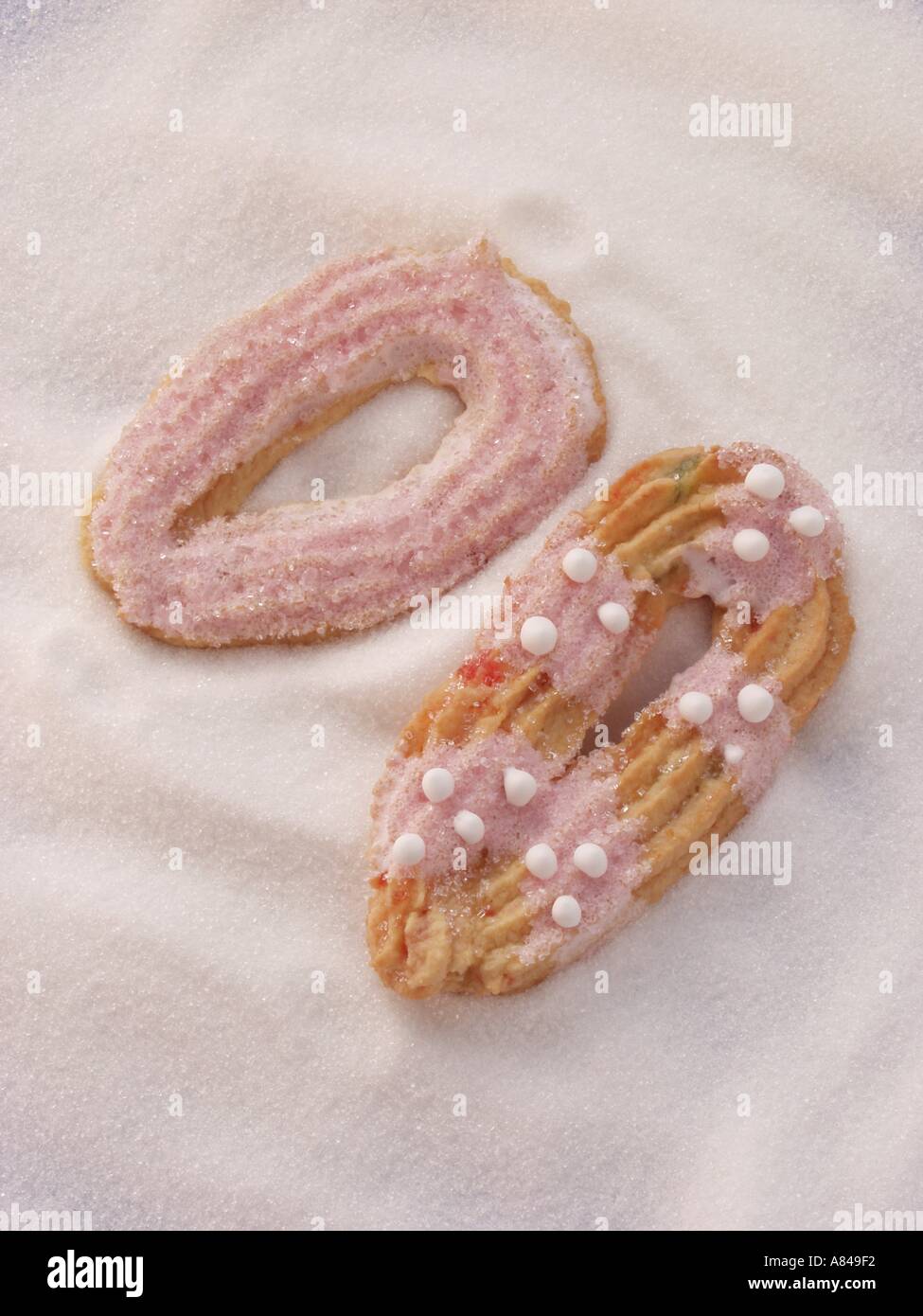 Piped biscuits with pink glace icing Stock Photo - Alamy