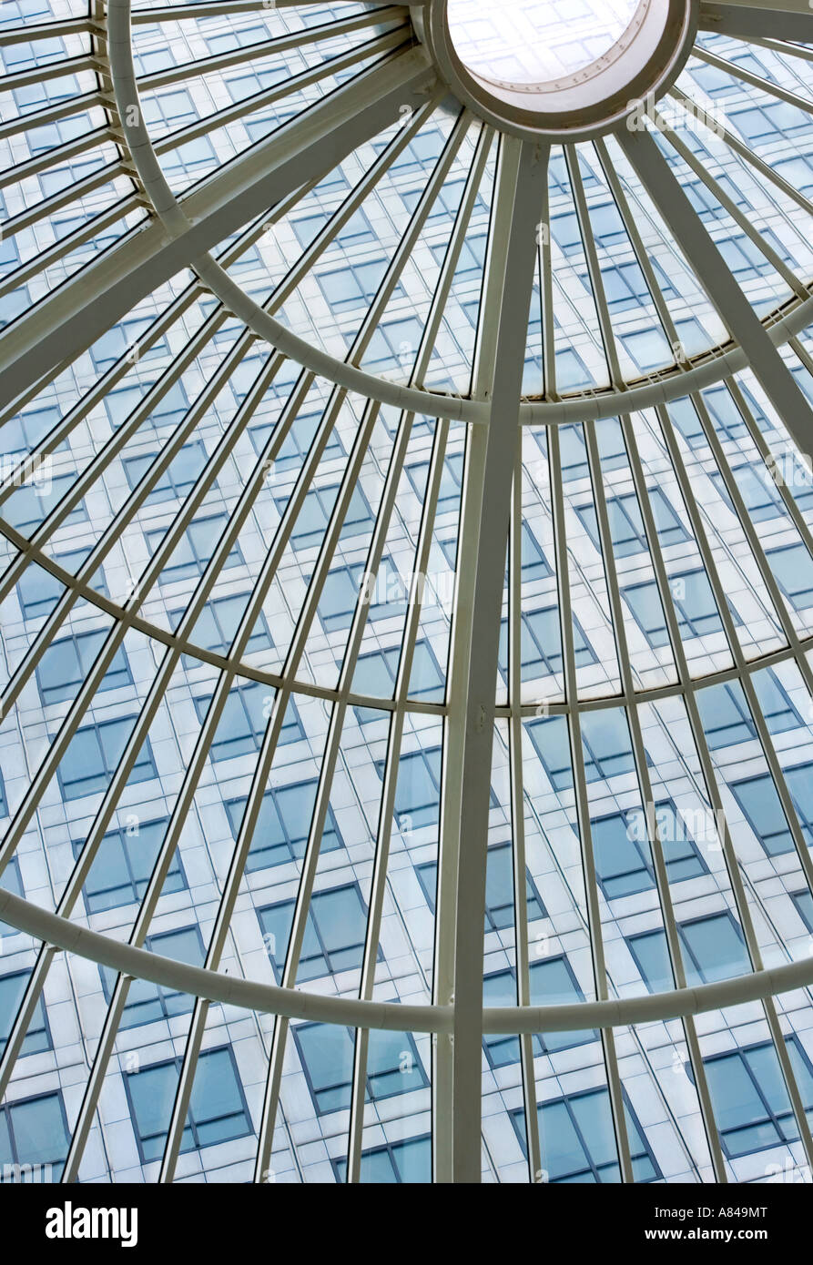 Looking through glass roof of neighbouring building to the Canary Wharf ...