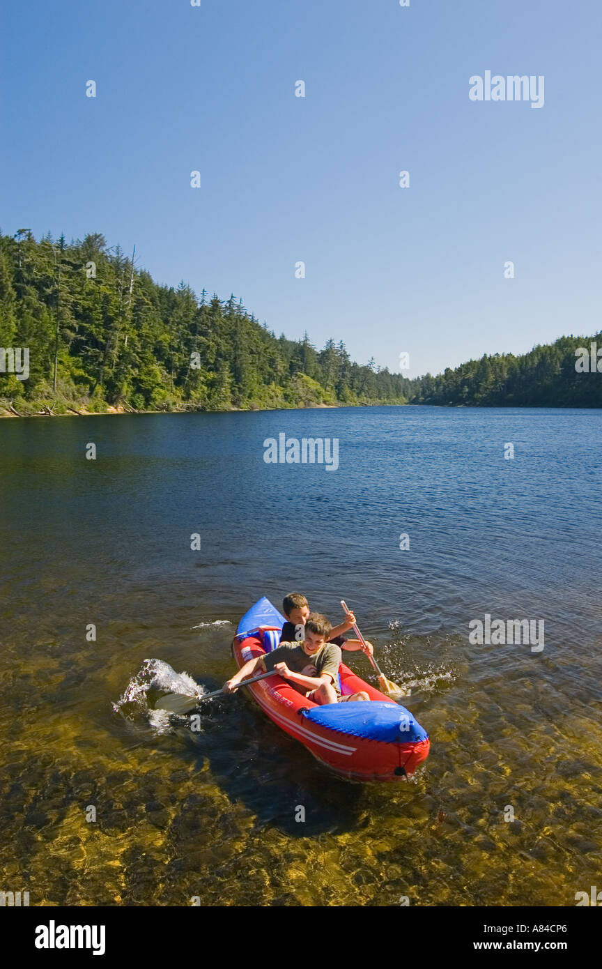 Two boys playing in inflatable kayak at Carter Lake Campground on the ...