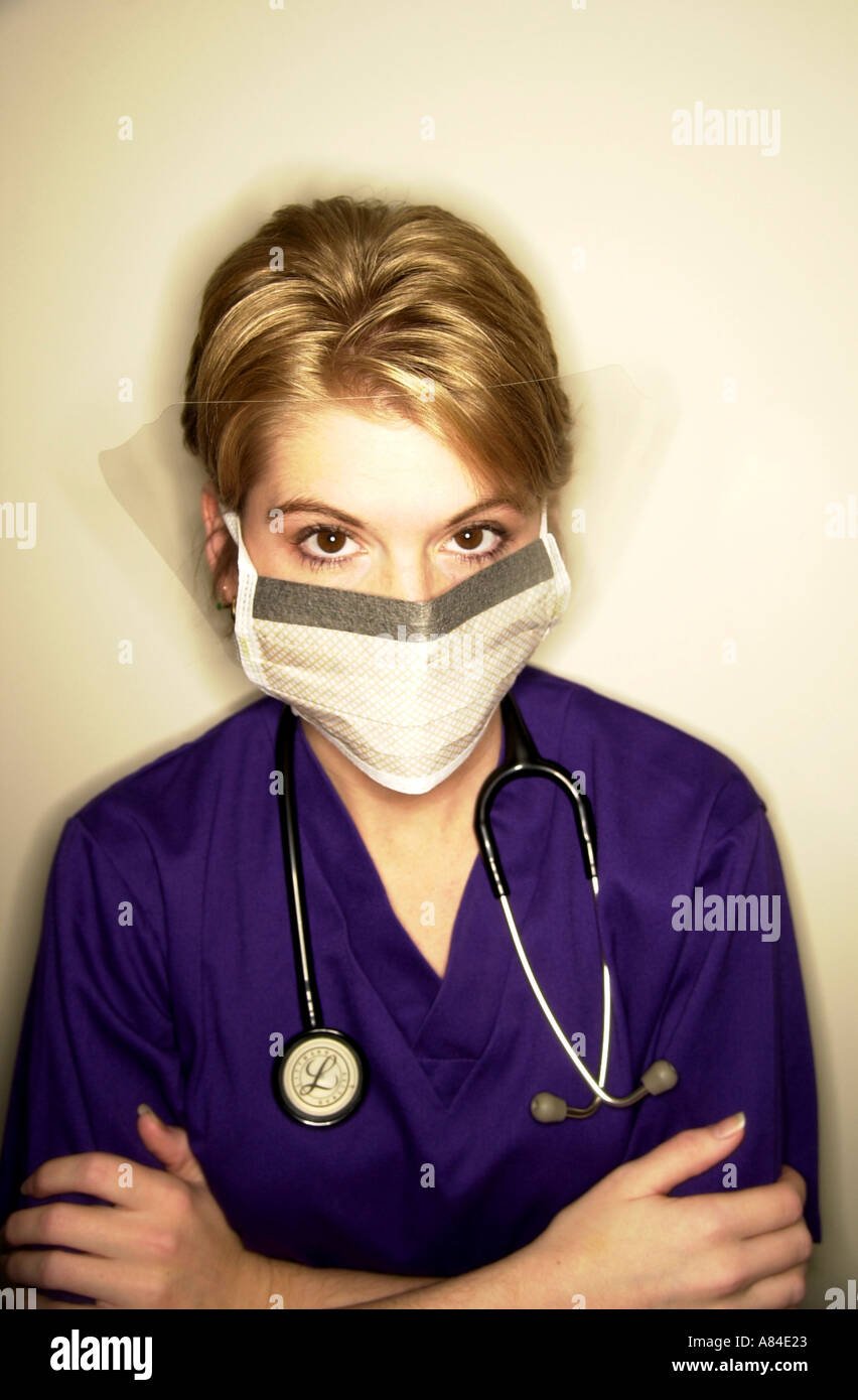 Vertical color image of a nurse wearing a surgical mask for protection ...