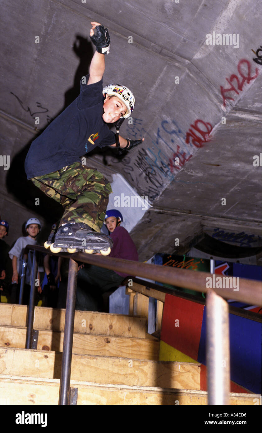 Young boy sliding down handrail at Skate Park , Notting hill, West ...