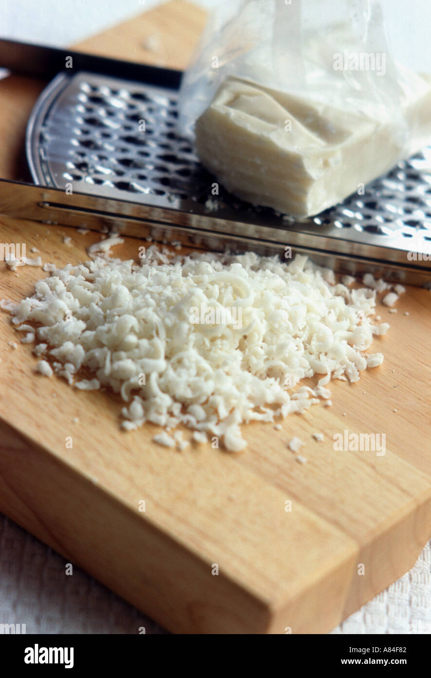Grating block of creamed coconut Stock Photo - Alamy