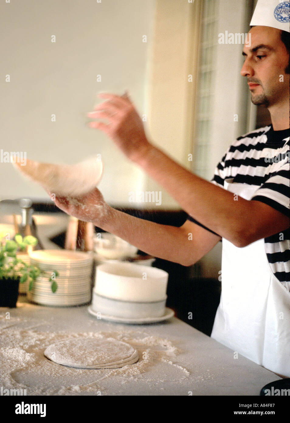 Tossing the dough to stretch ot for making pizza Stock Photo - Alamy