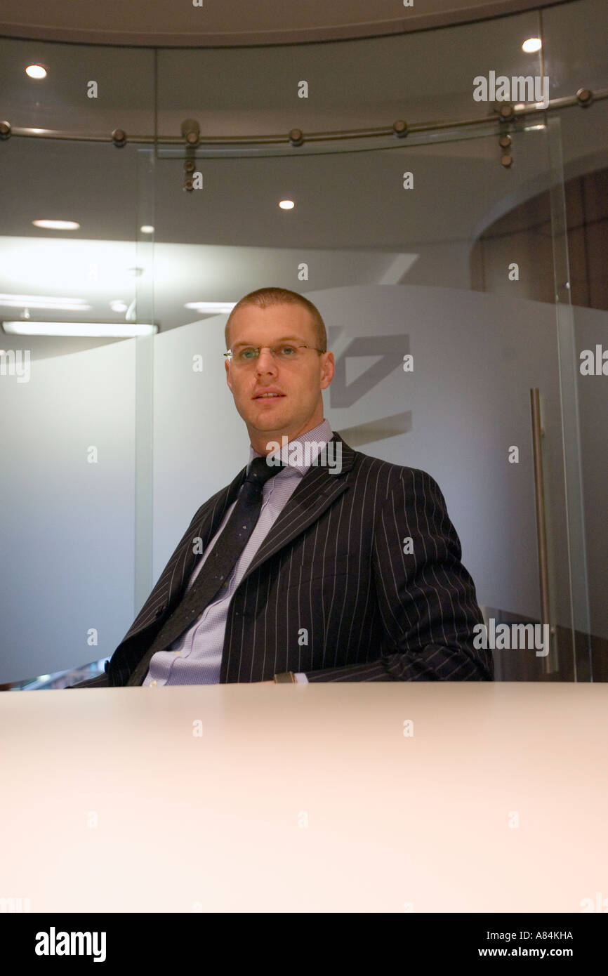 Businessman posing for a commercial photoshoot in office boardroom ...
