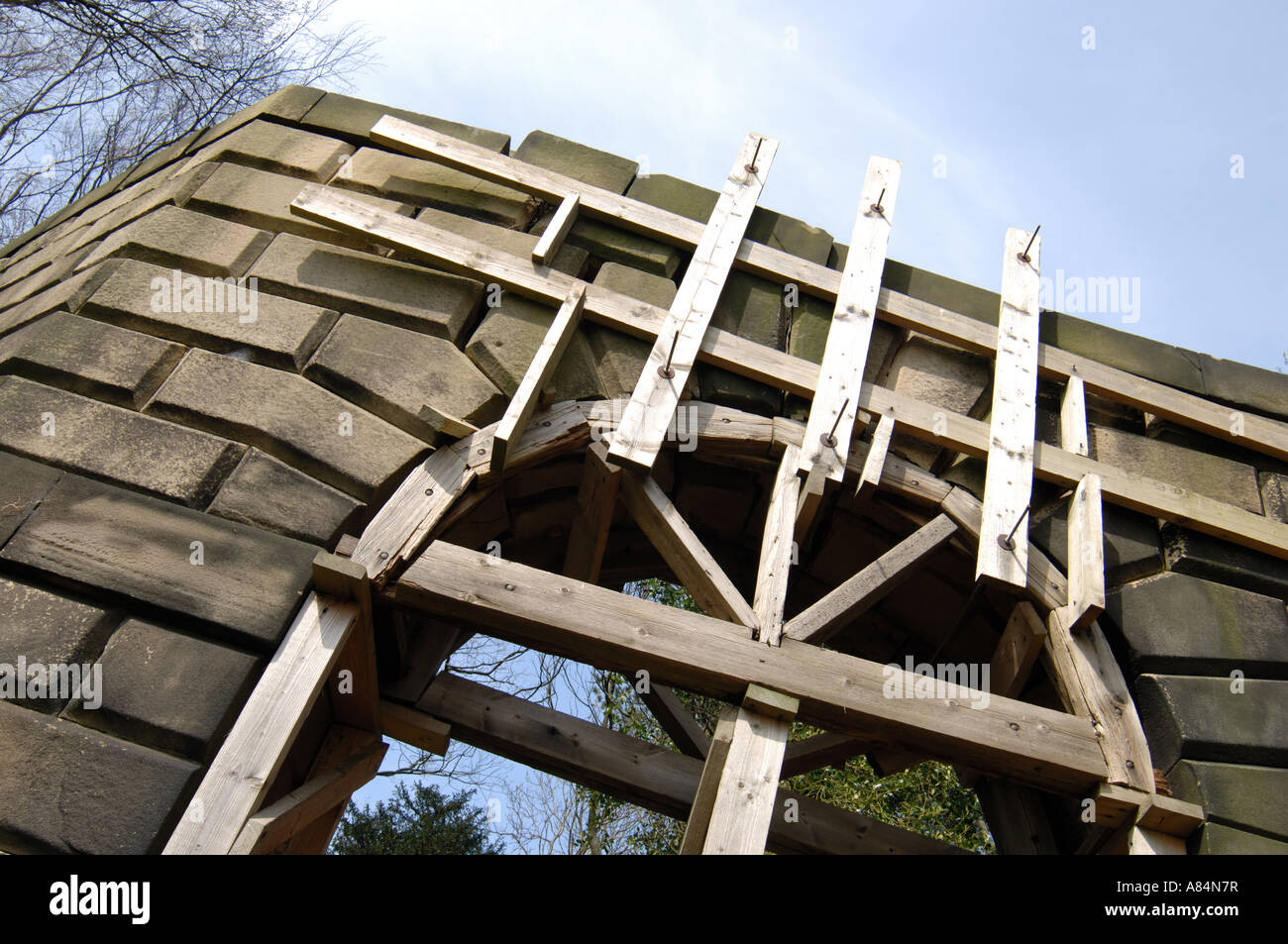 An arch in the process of rebuilding with wooden structures Stock Photo ...