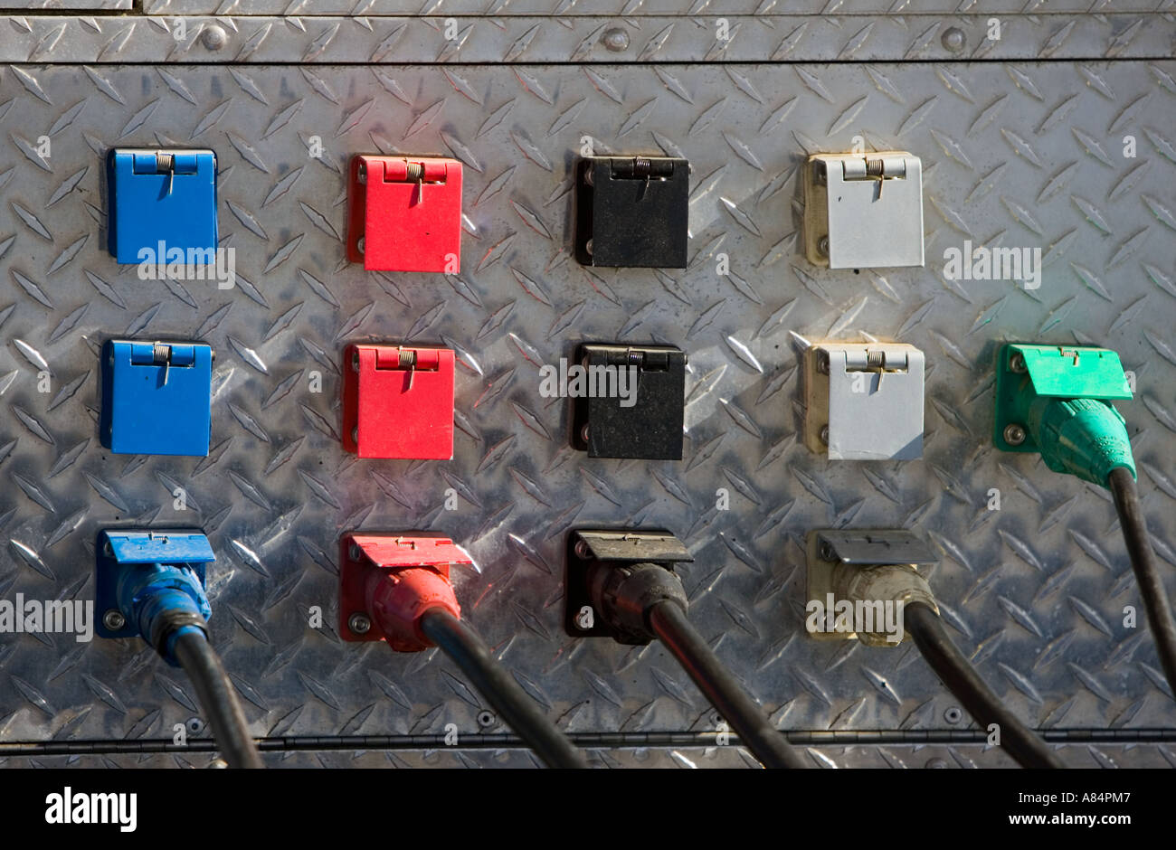 Plugs put in color coded sockets Stock Photo - Alamy