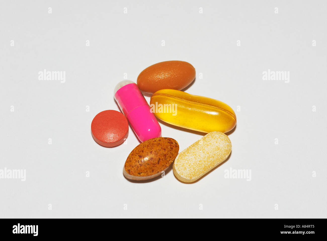 A selection of health supplement tablets against a white background ...