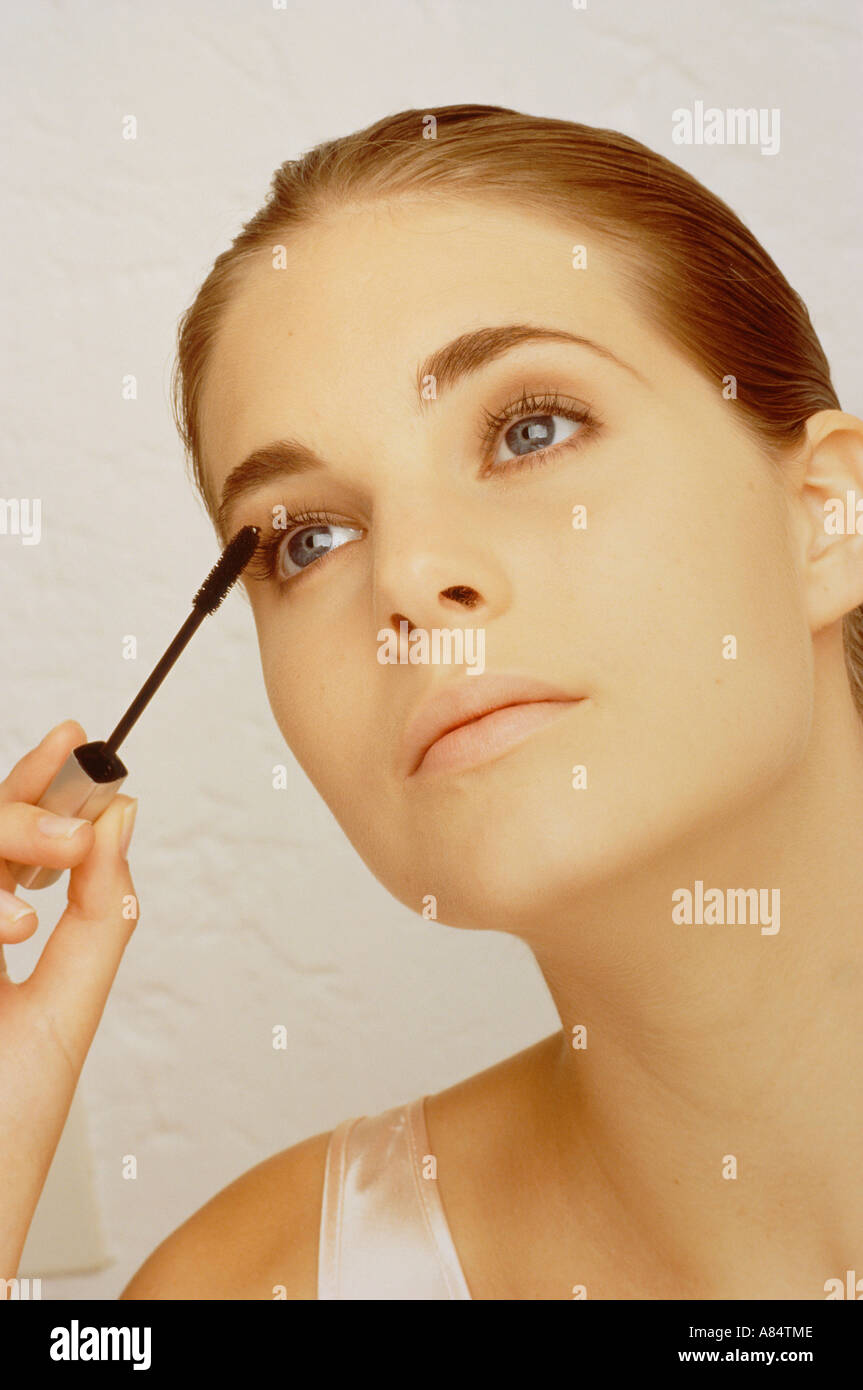 Studio portrait of young woman professional model applying makeup Stock ...