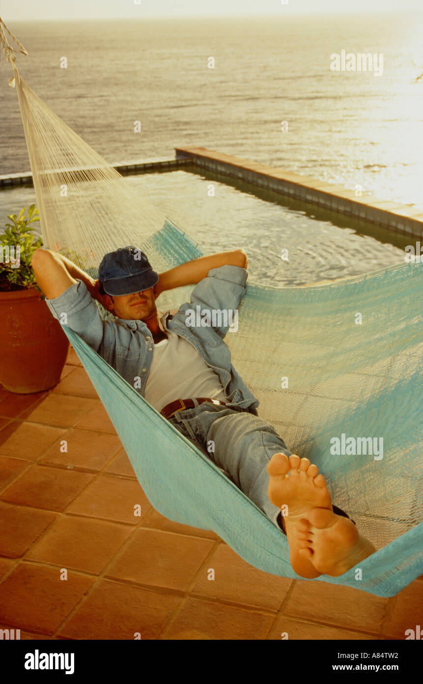 Man relaxing in a hammock Stock Photo - Alamy