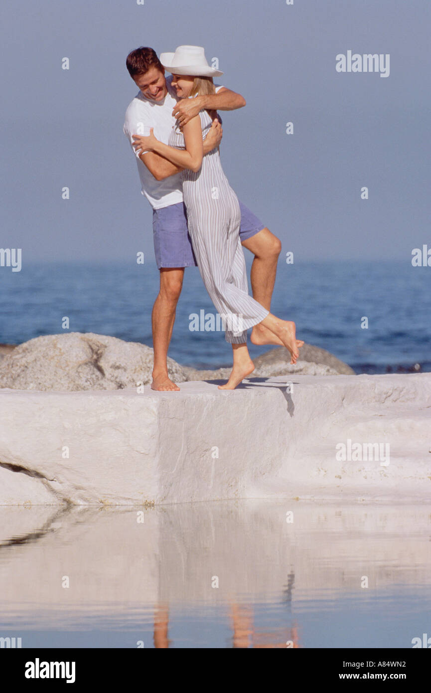 Young couple by seaside swimming pool Stock Photo - Alamy