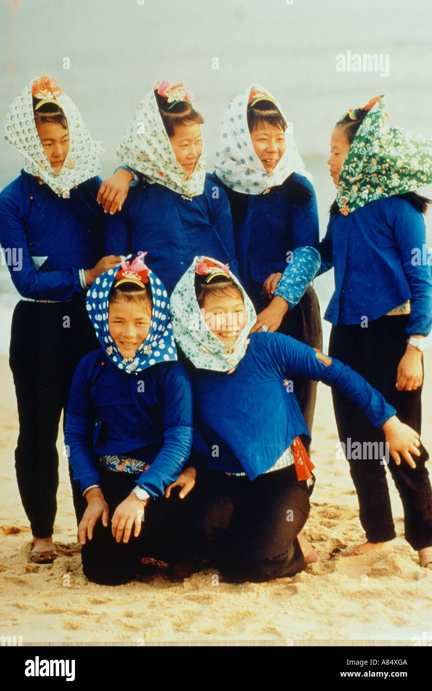 China. Fujian Province. Group of Hui'an maidens posing on sandy beach ...