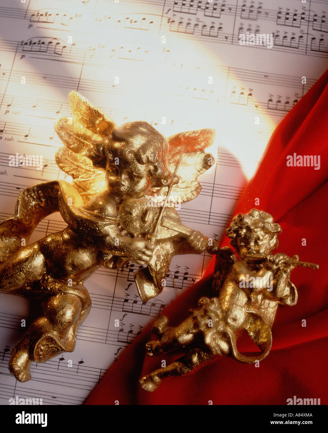 Still life. Music concept with sheet music and golden cherub figures ...