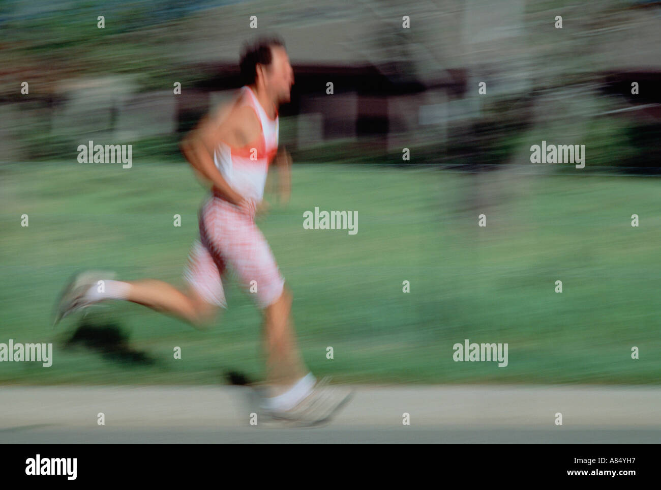 Side view of man running outdoors Stock Photo - Alamy