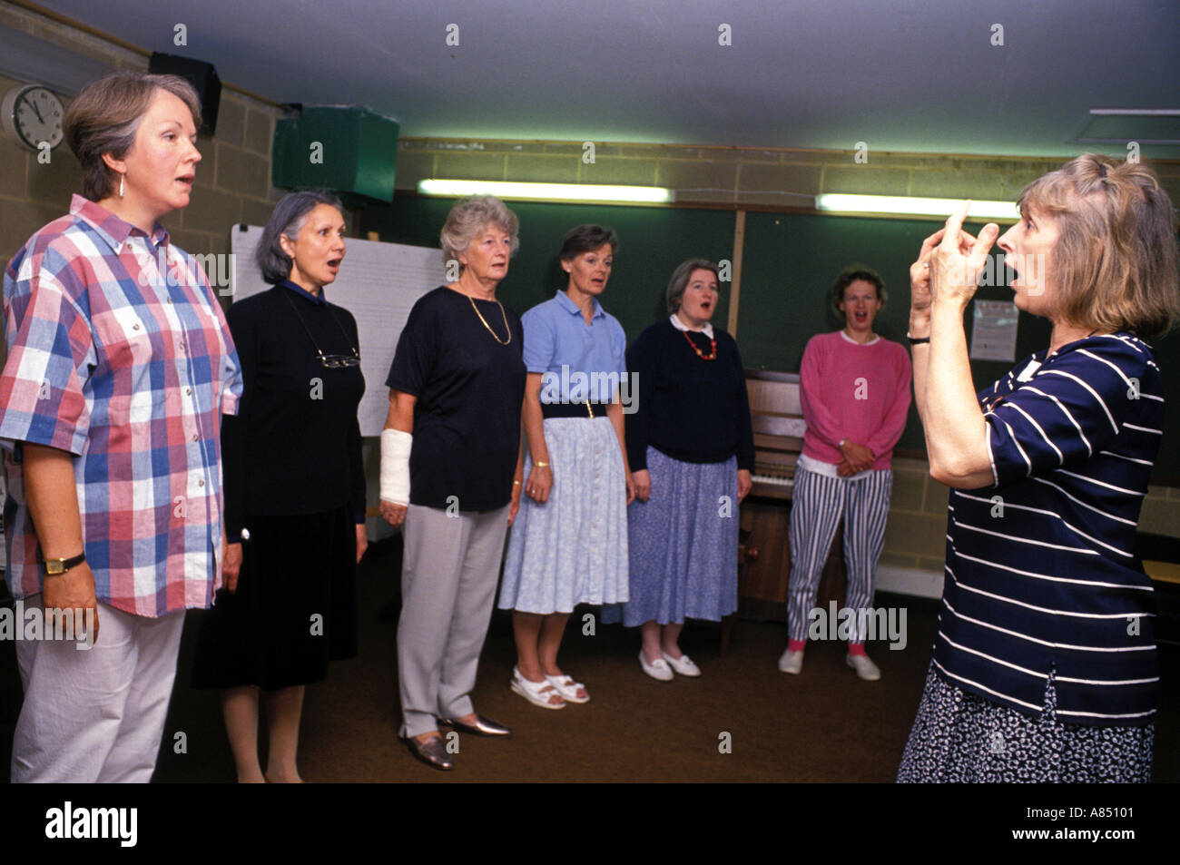 Teacher giving singing lesson to a mature student Stock Photo - Alamy