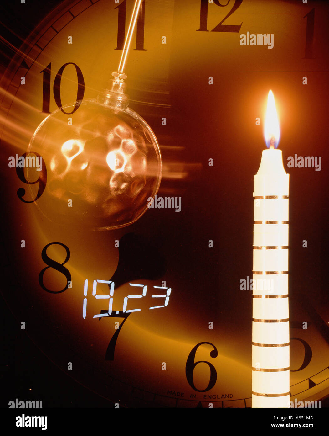 Time concept. Still life of swinging pendulum, candle and clockface ...