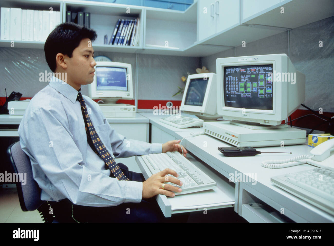 Philippines. Manila. Young man working in office with computer Stock ...