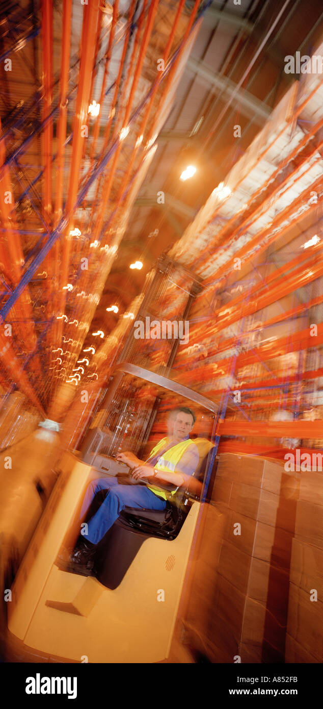 INTERIOR OF WAREHOUSE WITH FORKLIFT TRUCK AND DRIVER UK Stock Photo - Alamy