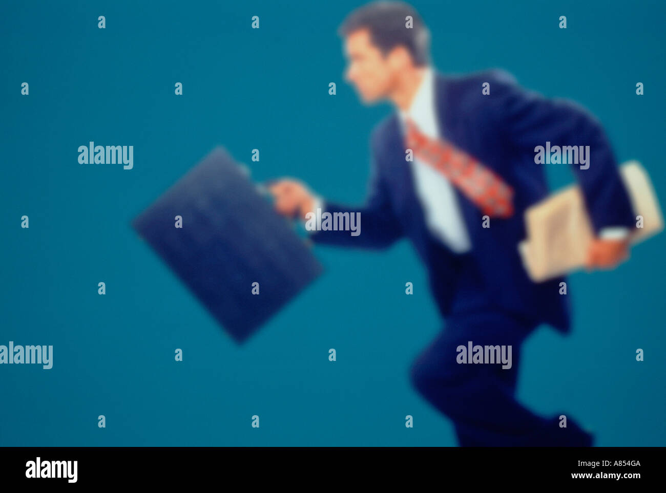 Blurred image of man in suit with briefcase running Stock Photo - Alamy