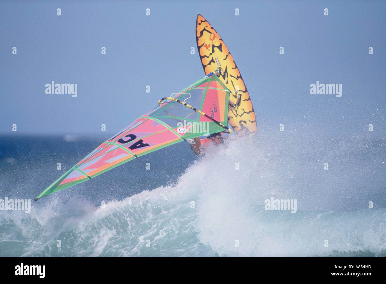 Windsurfing sailboard jumping ocean wave Stock Photo - Alamy