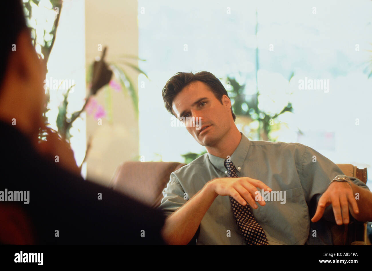 Back of mans head talking hi-res stock photography and images - Alamy