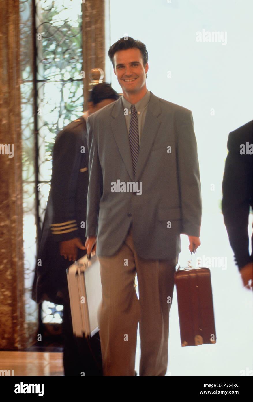 Young professional man arriving in hotel foyer. Singapore Stock Photo ...