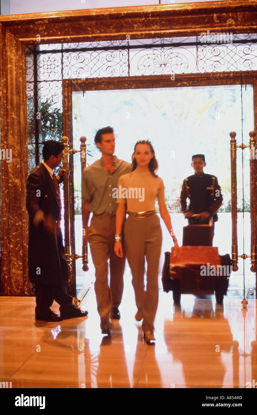 Young couple in hotel lobby. Singapore Stock Photo - Alamy