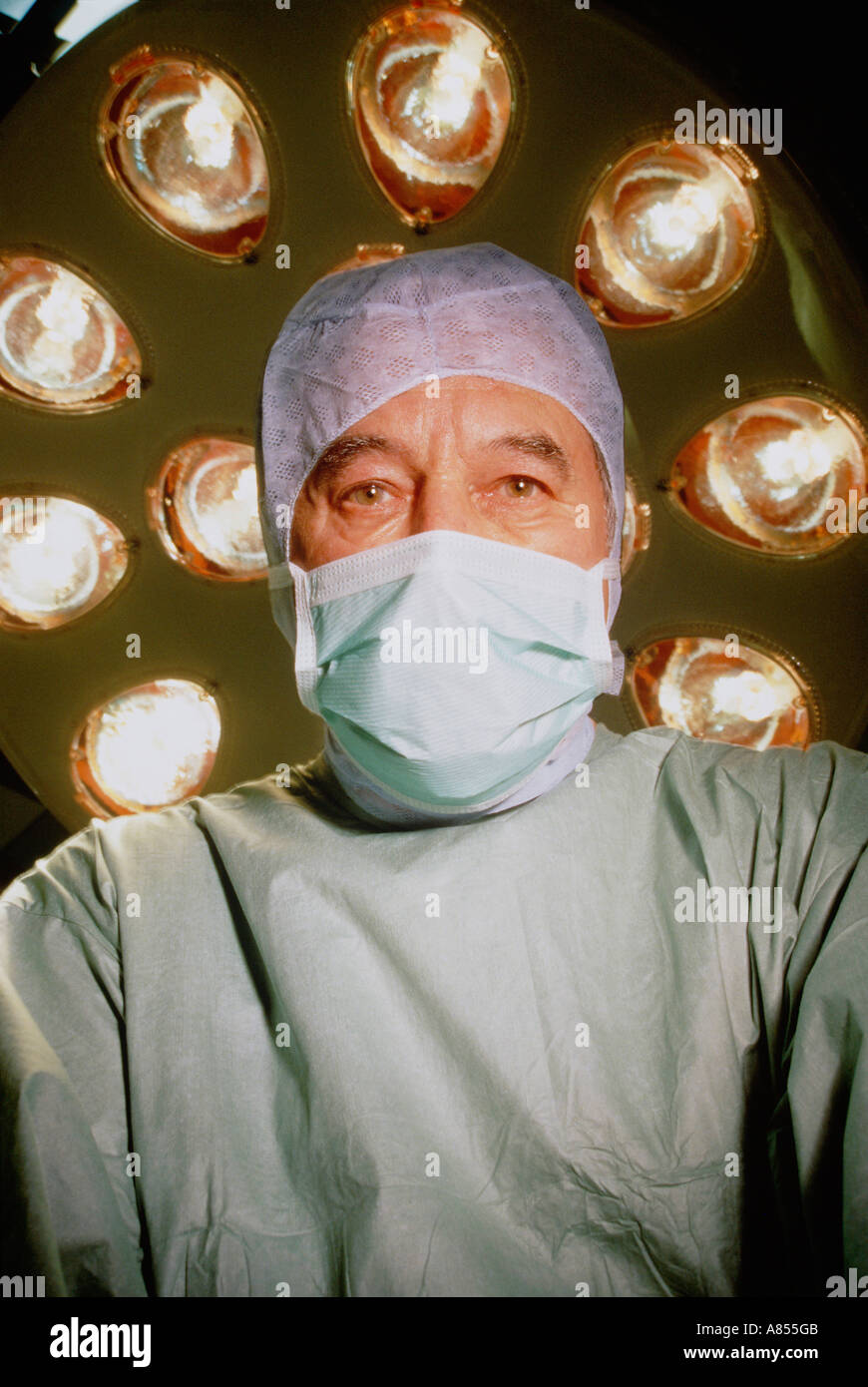 Indoor close-up portrait head and shoulders of male surgeon with ...