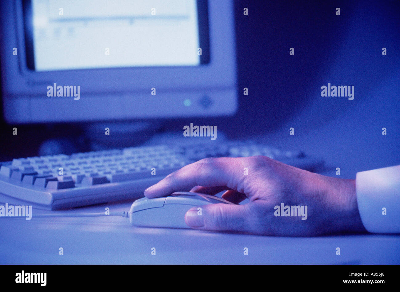 Close up of hand on computer mouse with monitor screen Stock Photo - Alamy