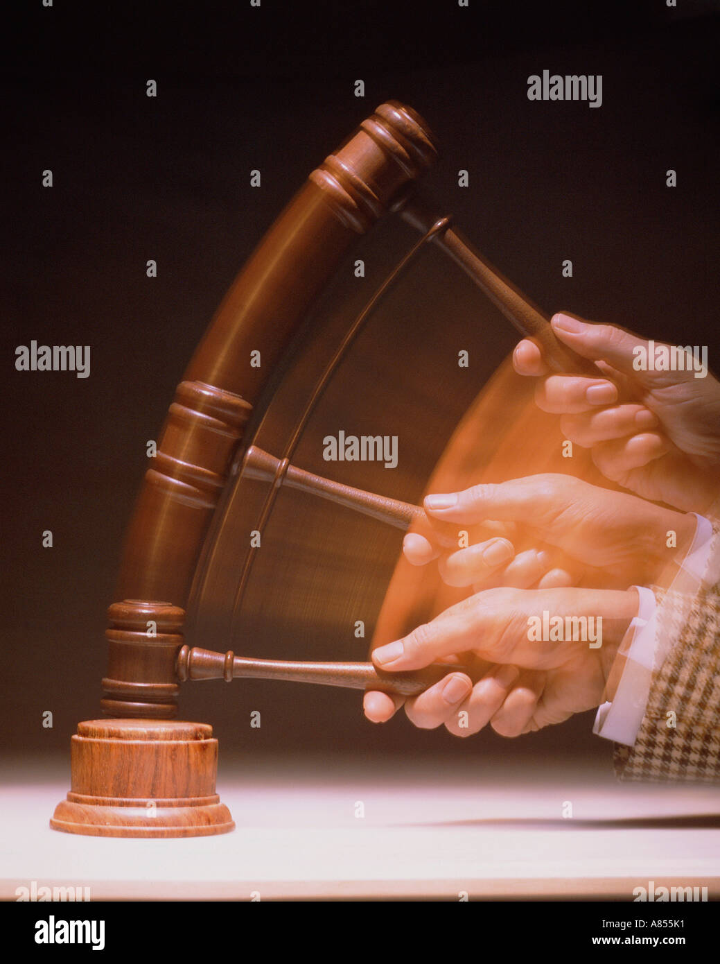 Indoor close-up of man's hand striking gavel on block Stock Photo - Alamy