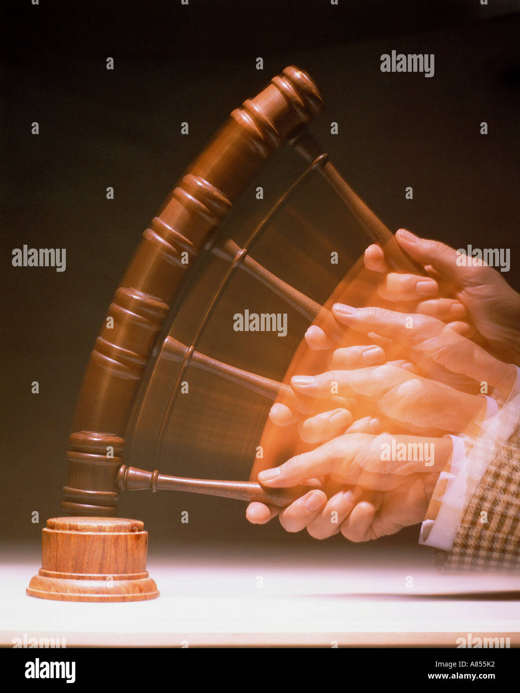 Indoor close-up of man's hand striking gavel on block Stock Photo - Alamy