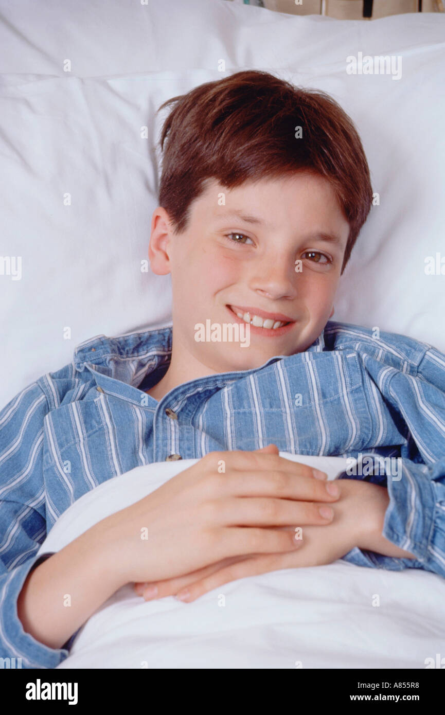 Close-up of sick child. Cheerful boy in hospital bed Stock Photo - Alamy
