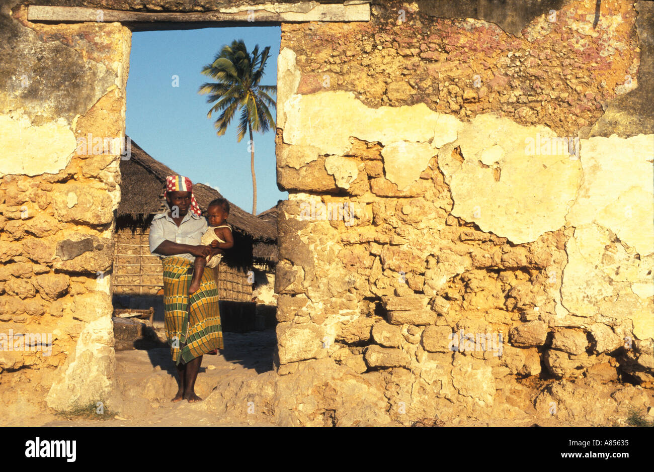 Woman with little child next to decayed stone wall Stock Photo - Alamy
