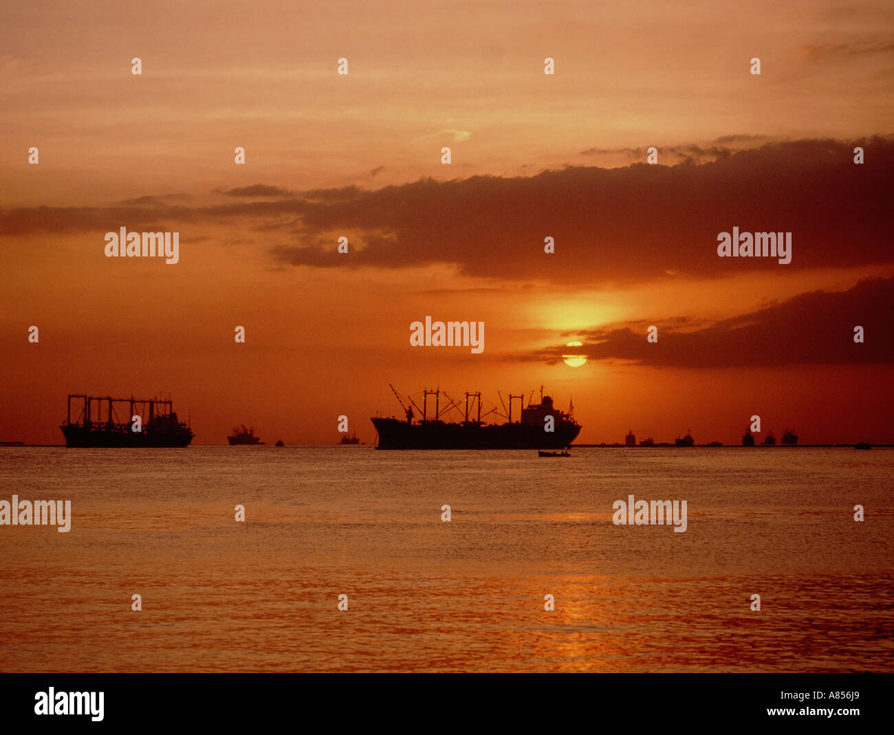 Philippines. Manila Bay. Commercial ships at sunset Stock Photo - Alamy