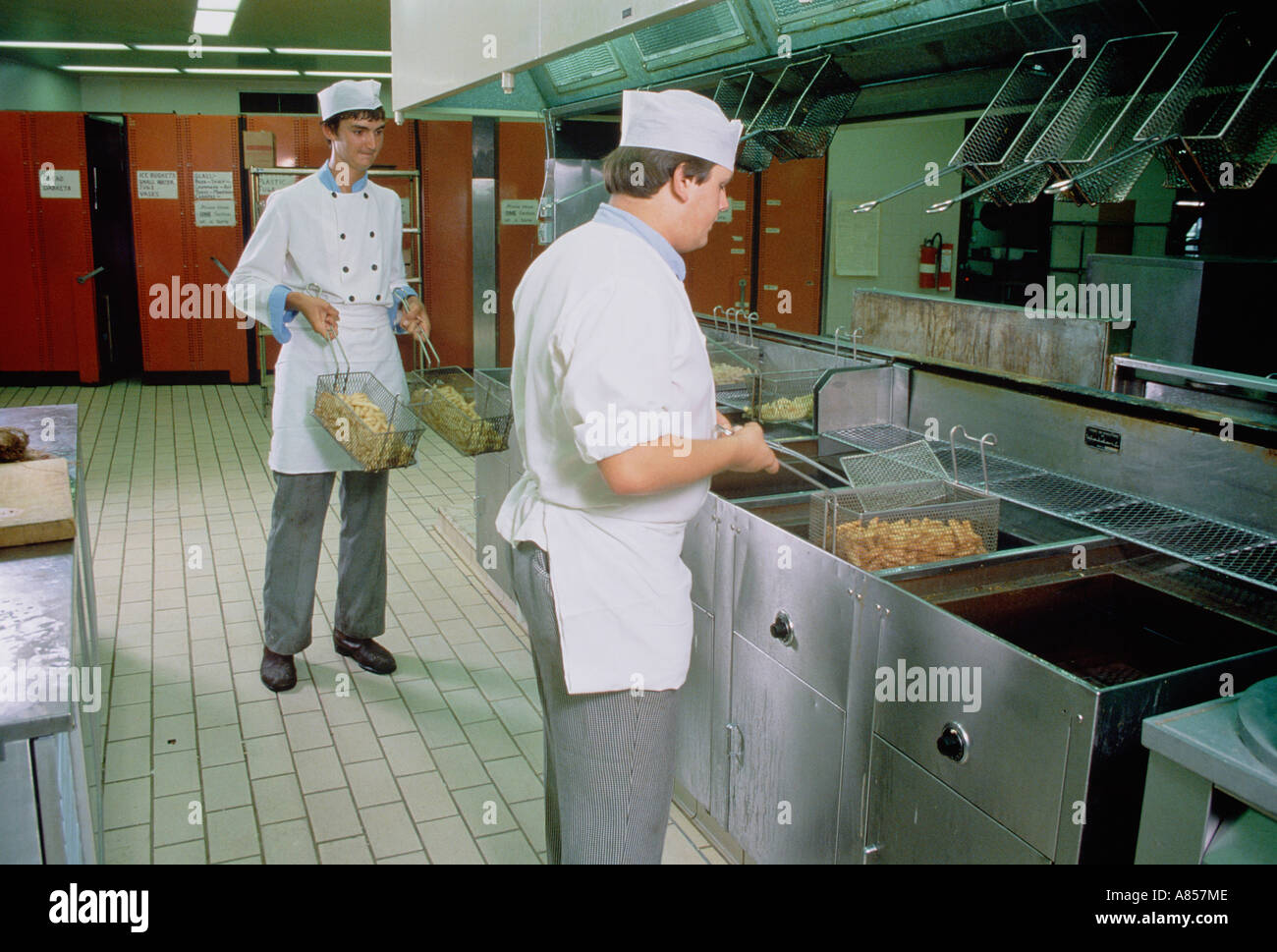 Chefs at deep fat fryer in canteen kitchen Stock Photo - Alamy
