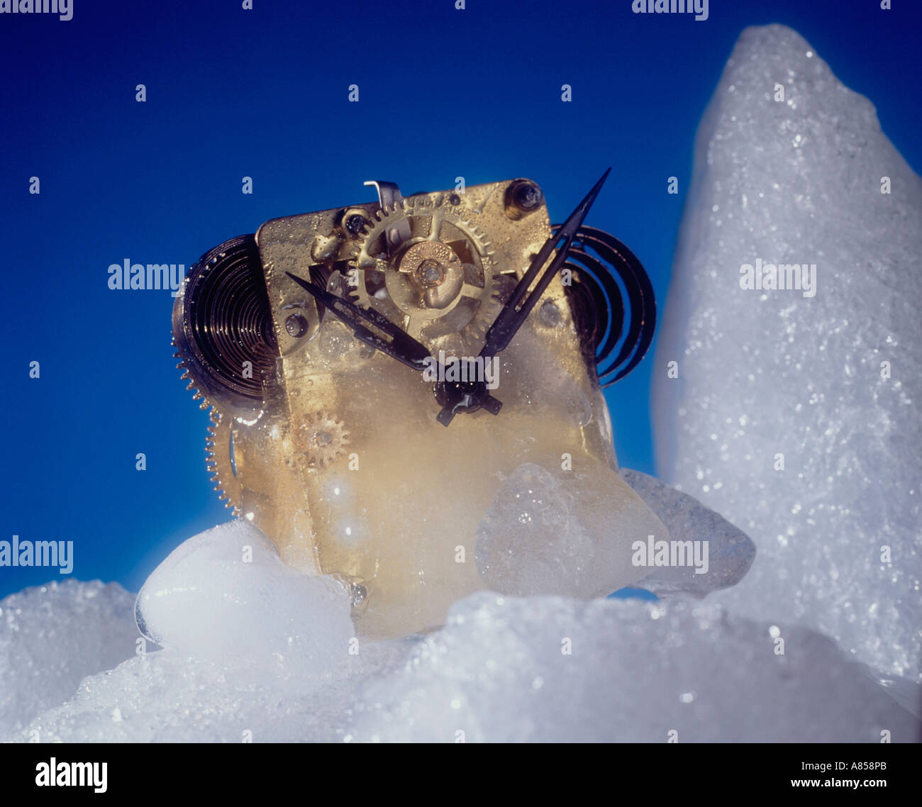 Still-life concept of clock mechanism frozen in ice Stock Photo - Alamy