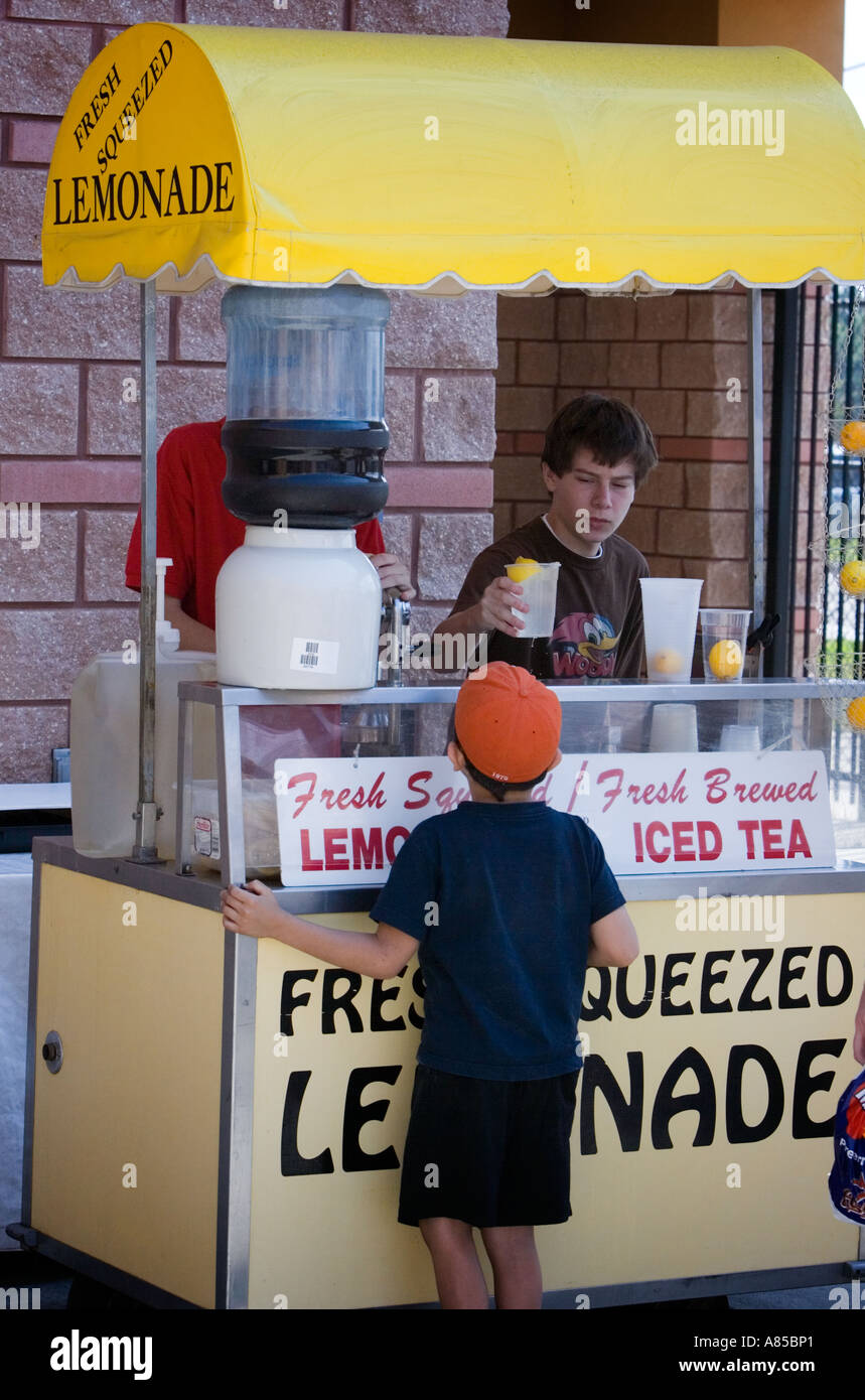 Young boy buying lemonade at a refreshment stand Stock Photo - Alamy