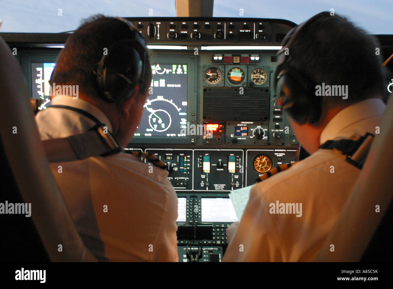 Pilot and co-pilot at the controls of a small passenger jet Stock Photo ...
