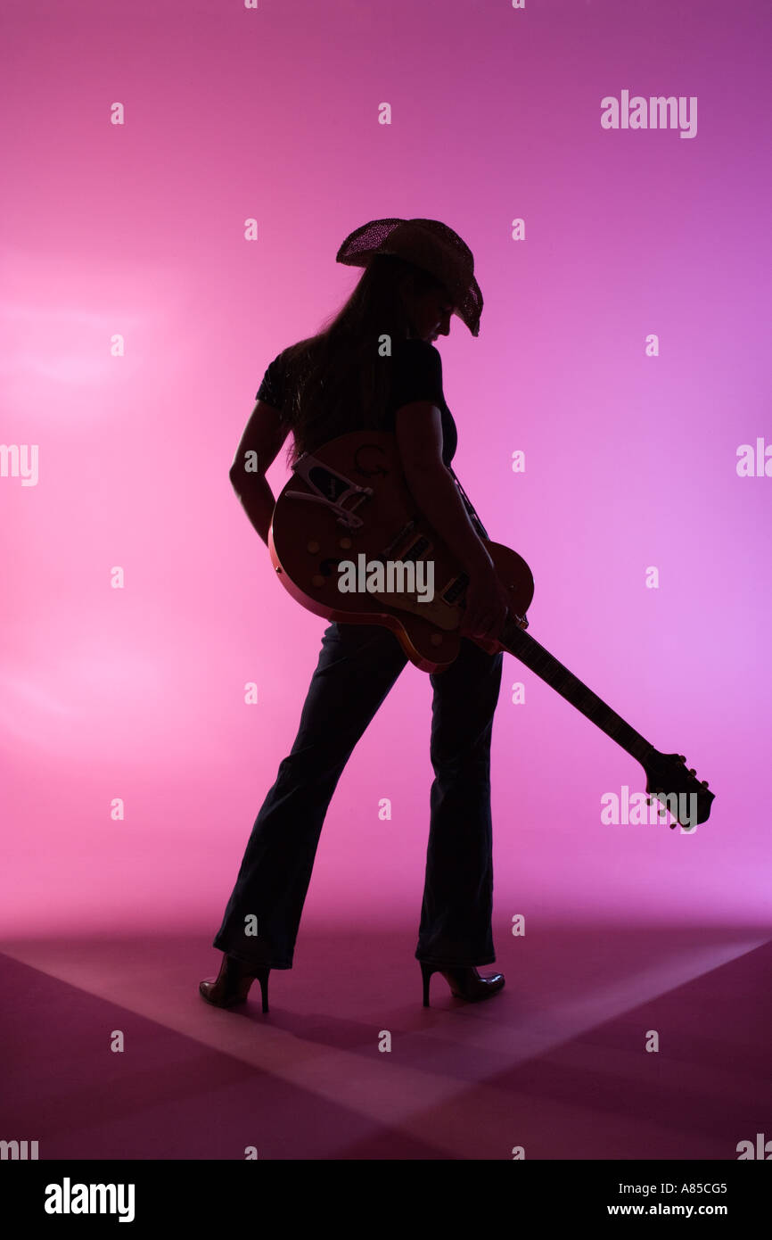 Silhouette of woman and guitar Stock Photo - Alamy