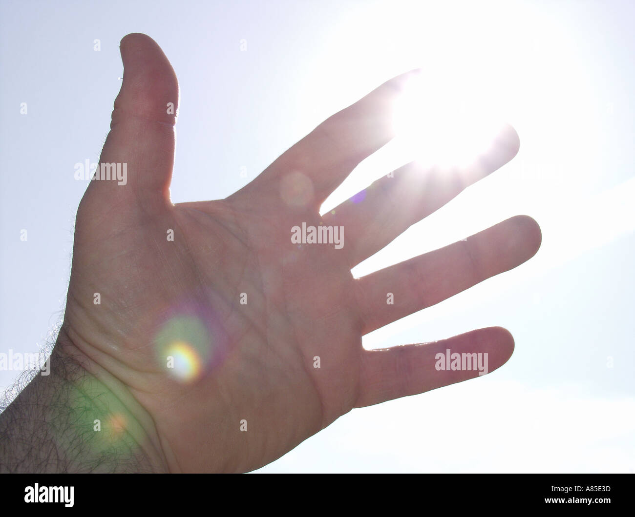 Hand in light Stock Photo - Alamy