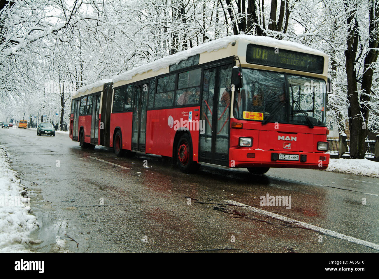 Bus on a City Street in Winter Snow Stock Photo - Alamy