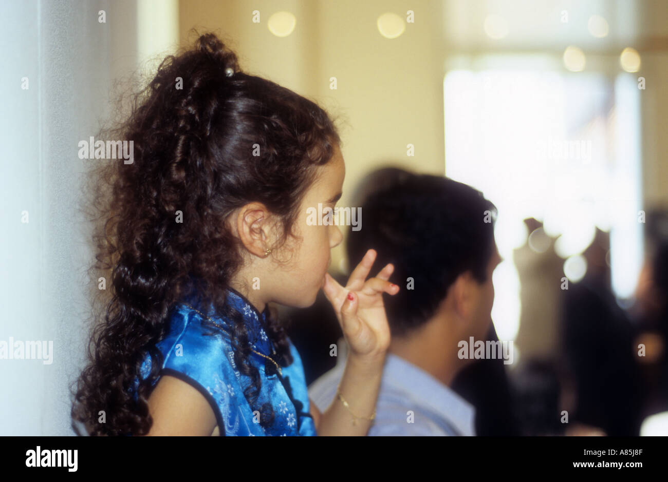 girl with her finger in her mouth Stock Photo - Alamy