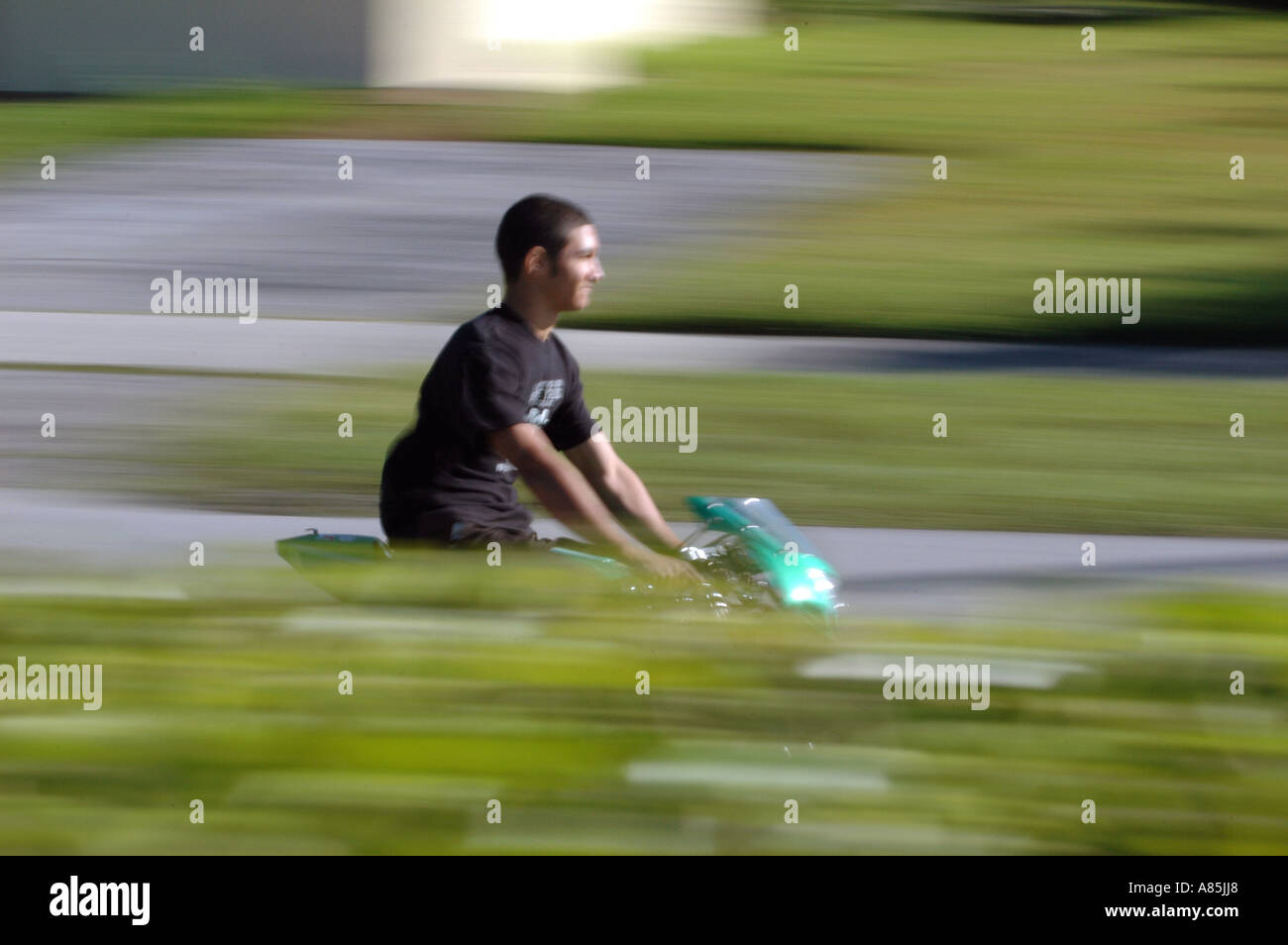 Young boy racing on a mini motorbike Stock Photo - Alamy