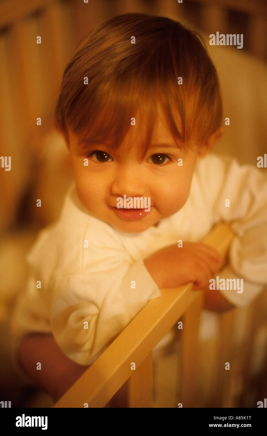 HAPPY BABY STANDING IN CRIB Stock Photo - Alamy