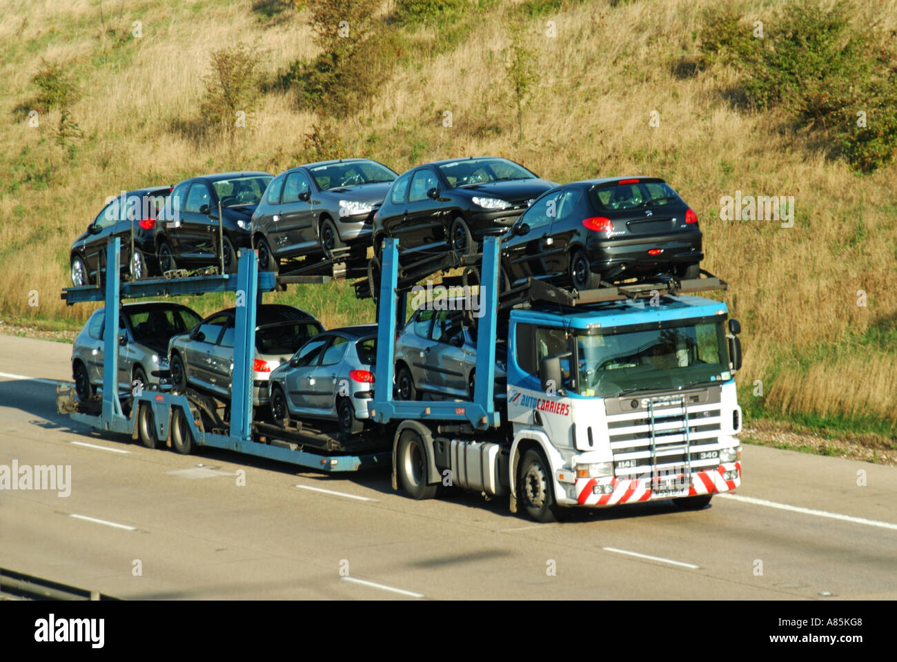 Side and front view of hgv haulage lorry truck & driver with new cars ...