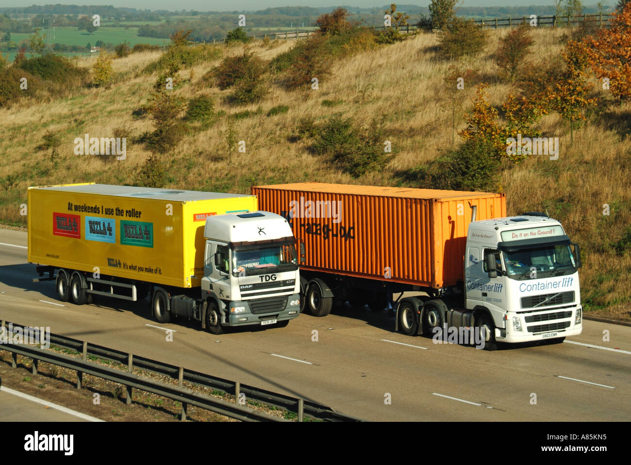 M25 motorway two articulated lorries overtaking Stock Photo - Alamy