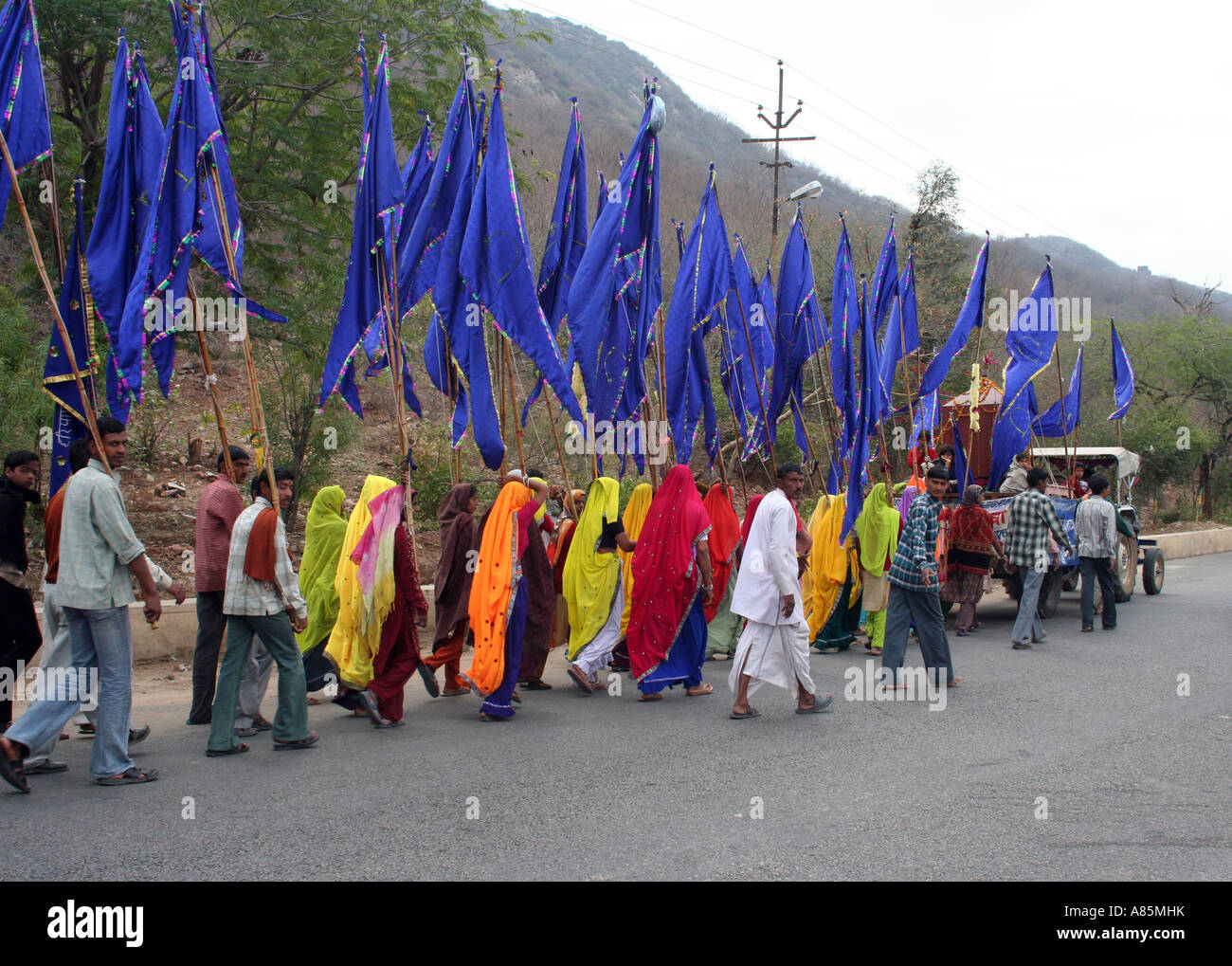 Pilgrims carrying blue flags in the mountains surrounding Jaipur ...